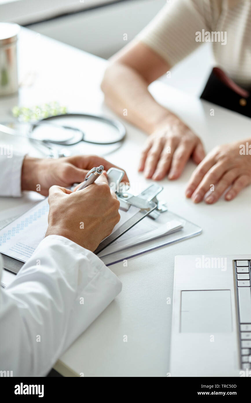 Doctor writing prescription Stock Photo - Alamy