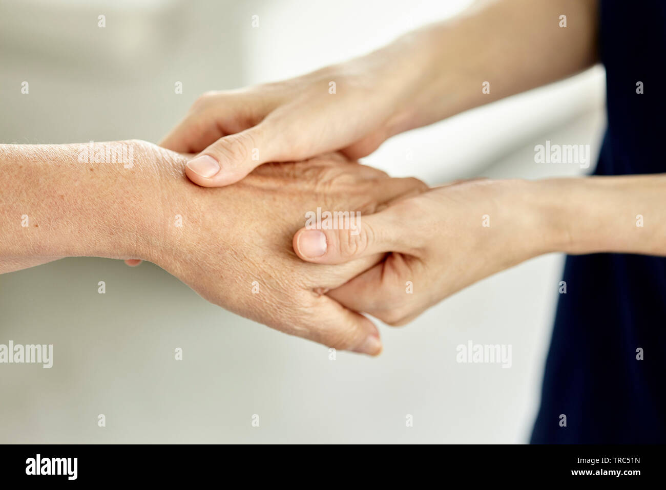 Nurse holding patient's hand Stock Photo - Alamy
