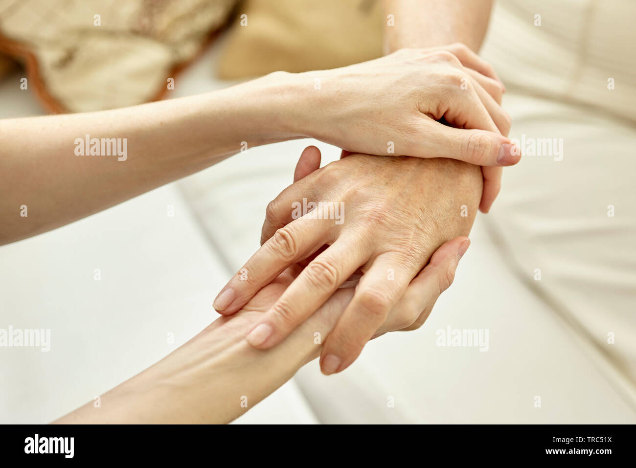 Nurse holding patient's hand Stock Photo - Alamy