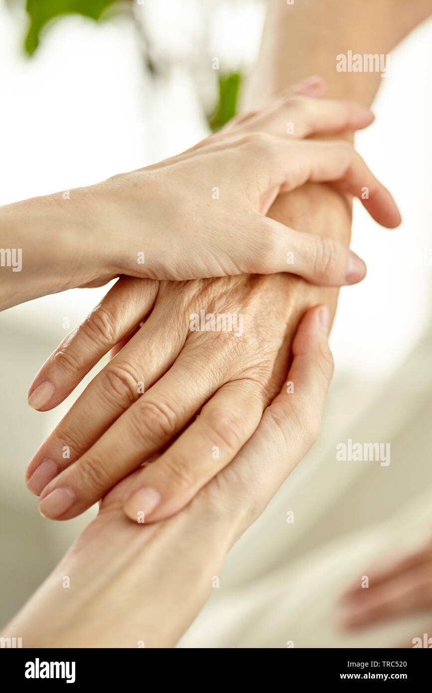 Nurse holding patient's hand Stock Photo - Alamy