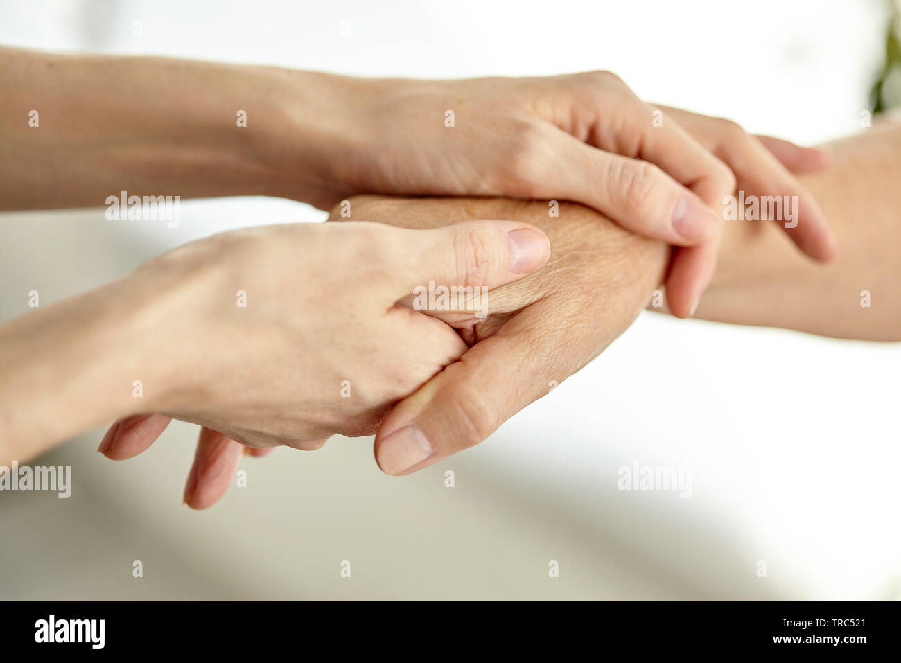 Nurse holding patient's hand Stock Photo - Alamy