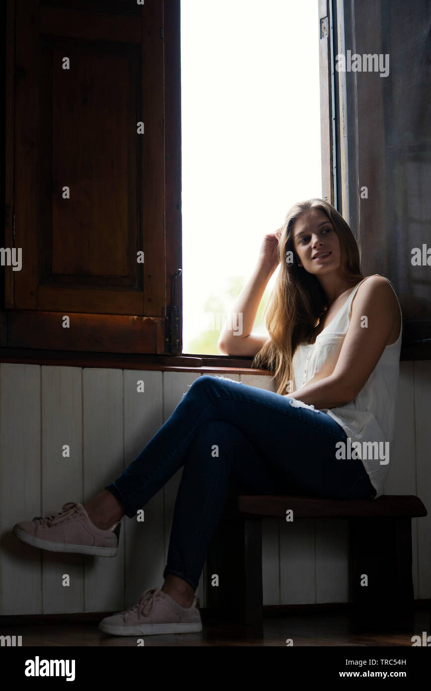 Woman sitting near window hi-res stock photography and images - Alamy