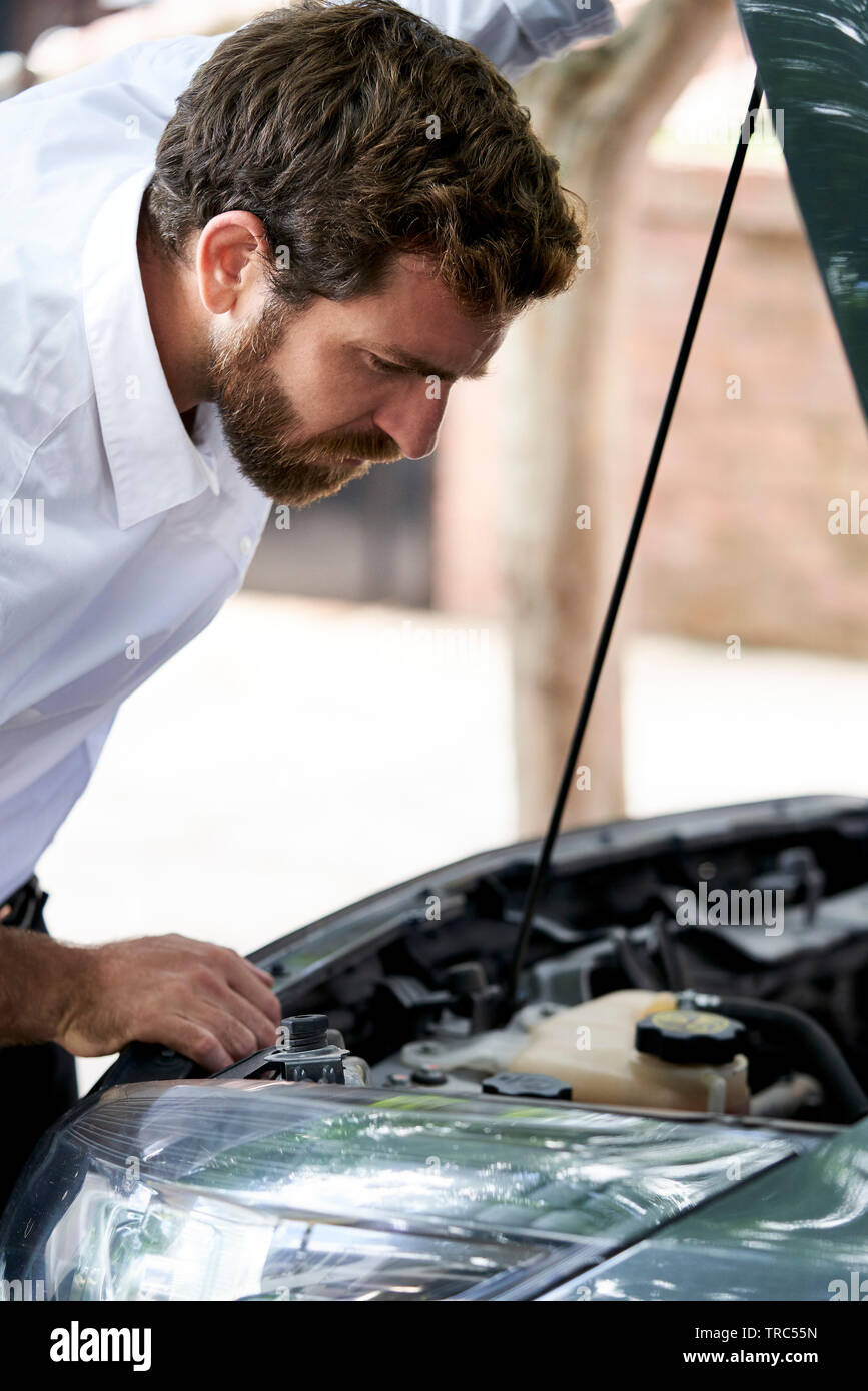 Man looking at car engine Stock Photo - Alamy