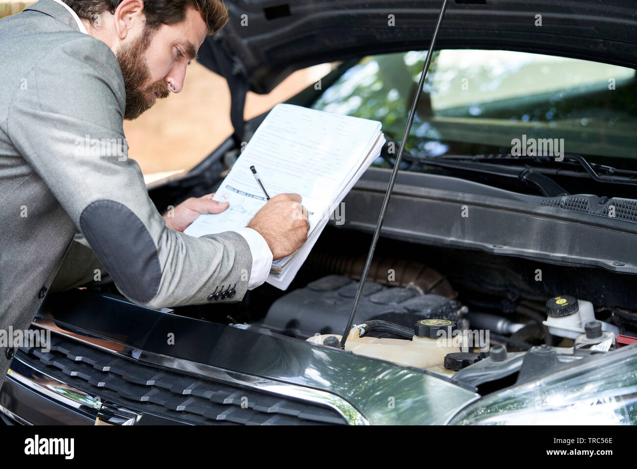 Man writing on documents Stock Photo - Alamy