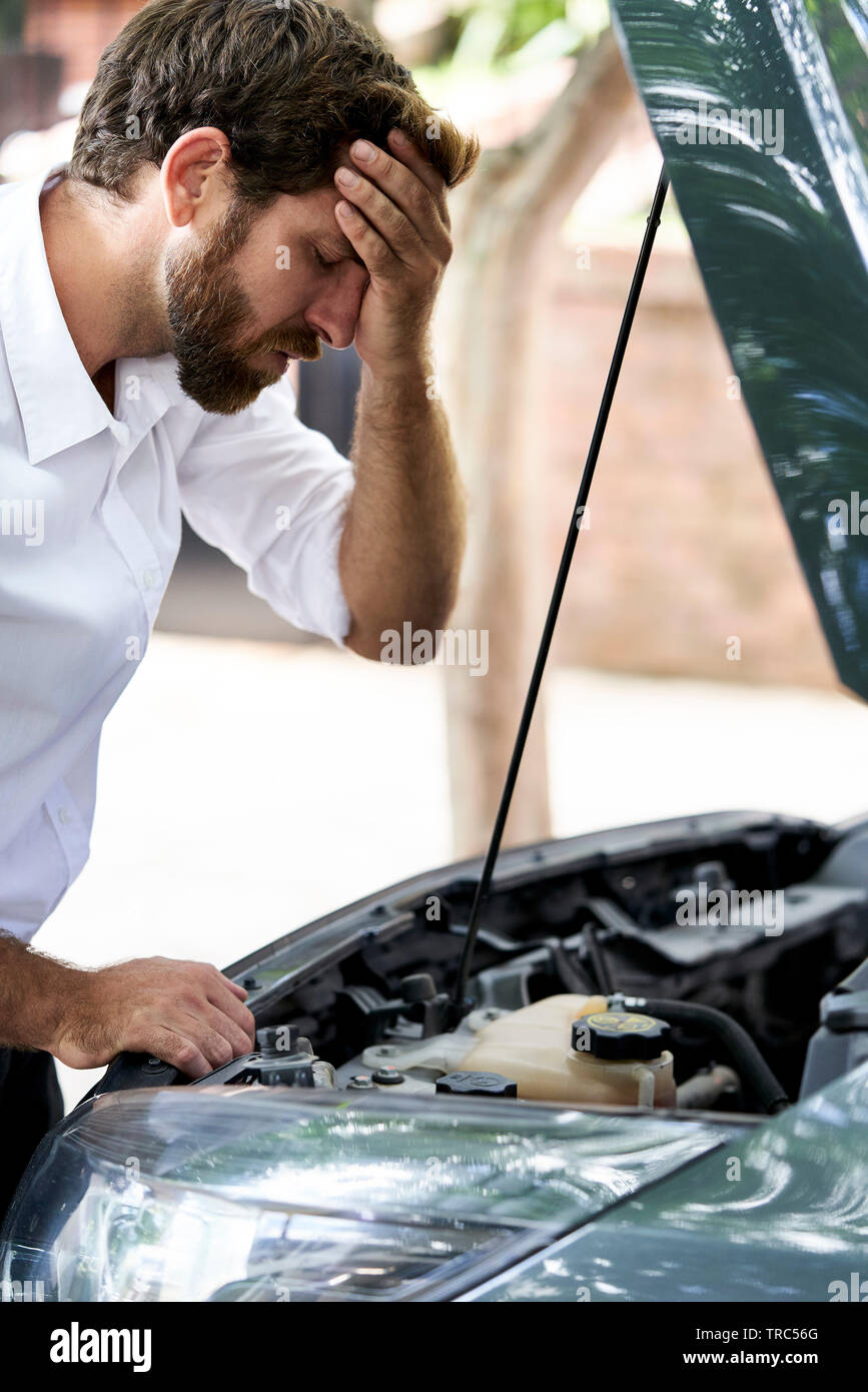 Frustrated man standing by car Stock Photo - Alamy