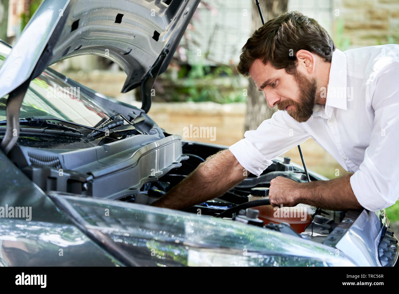Man checking car engine Stock Photo - Alamy