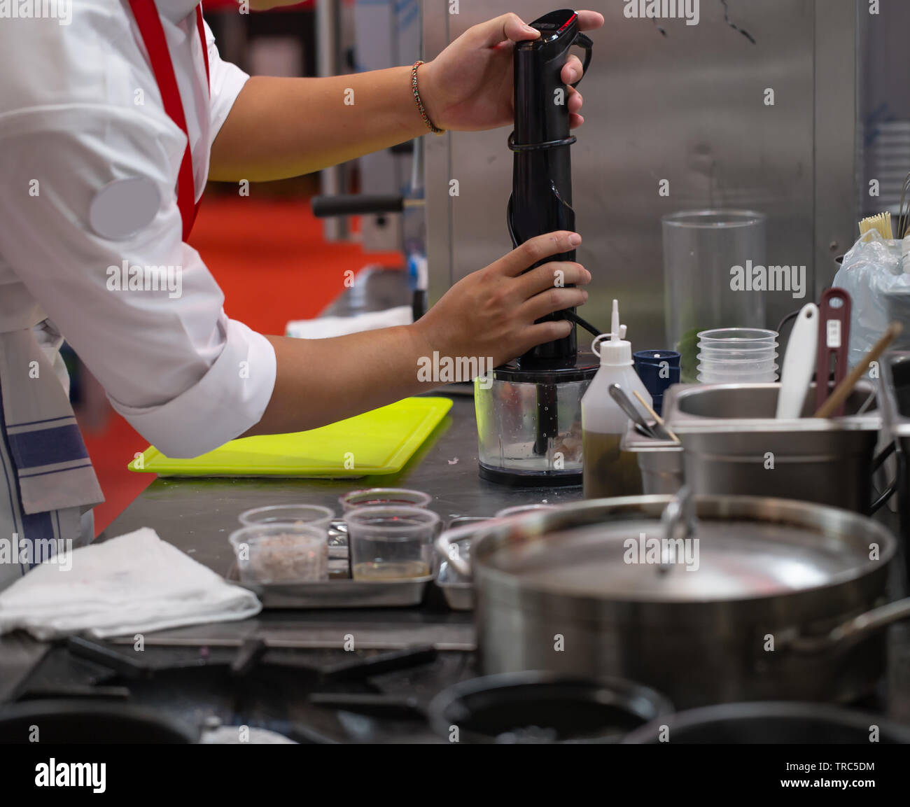 Chef blending meat in hand stick blender Stock Photo - Alamy