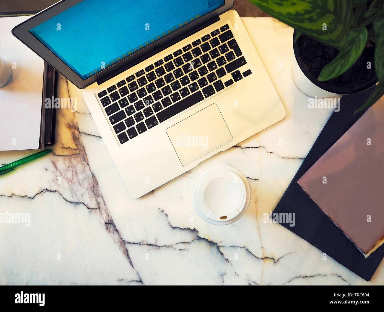 Laptop with blank white screen on marble table in modern cafe with ...