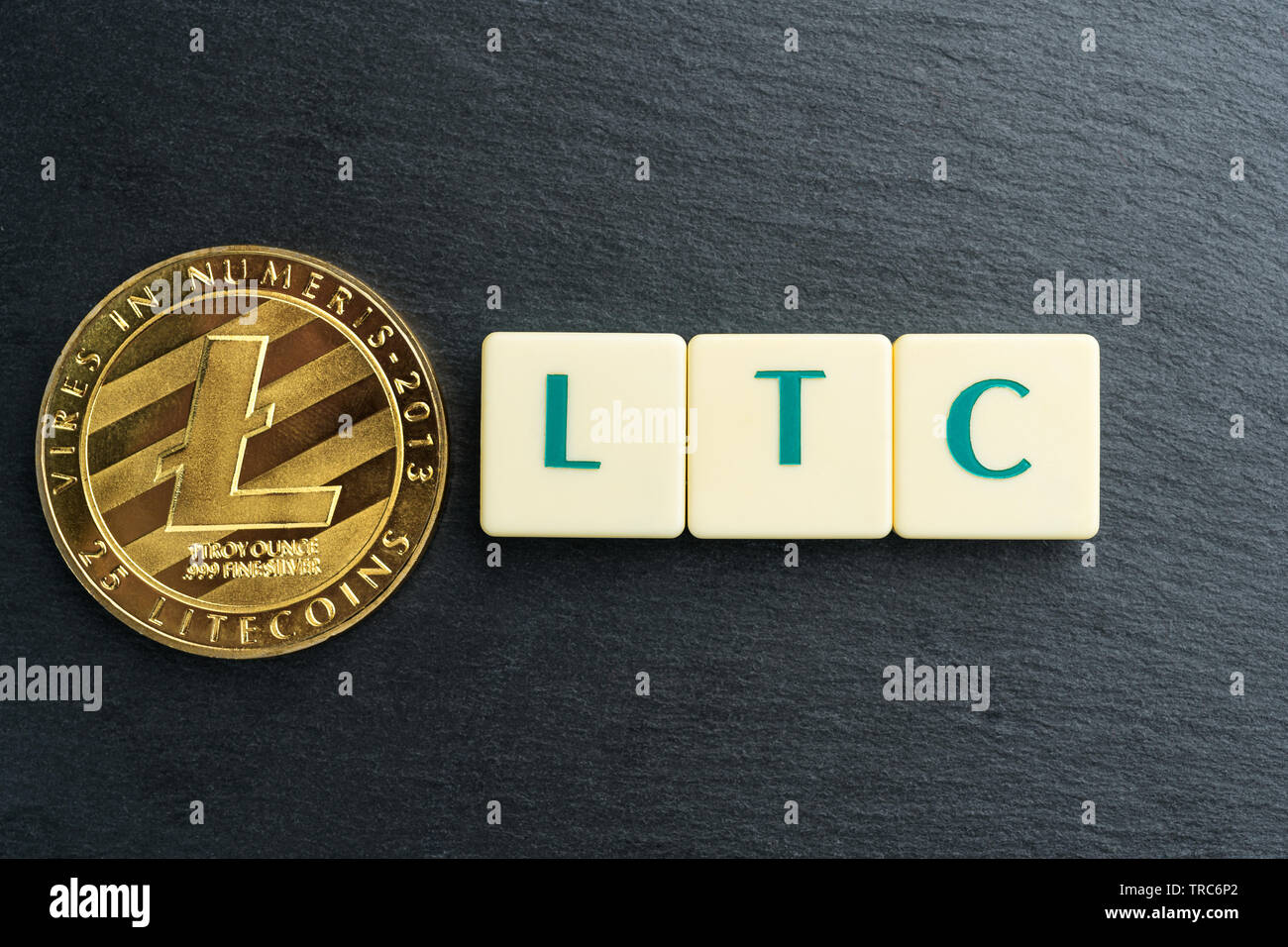 Physical Litecoin gold coin with text made out of letter tiles ...
