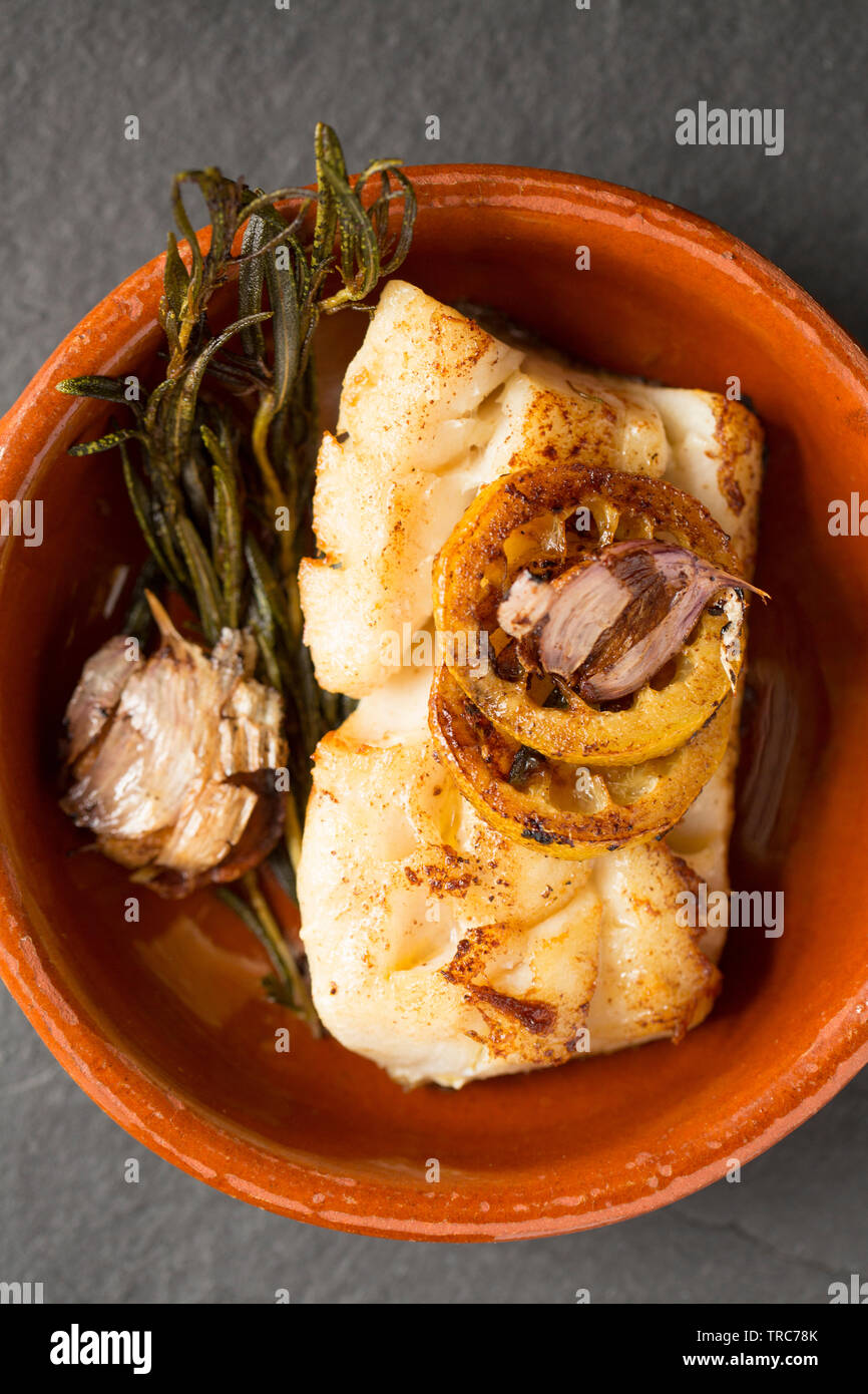 A cooked, thick fillet of pollack, Pollachius pollachius, that was ...