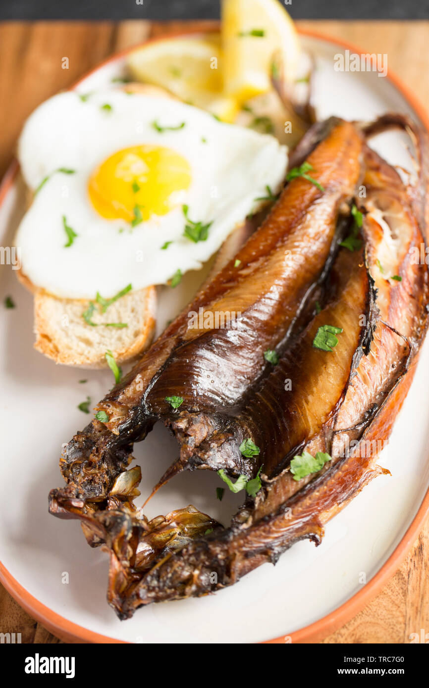A grilled cold-smoked Craster Kipper made from an Atlantic herring ...