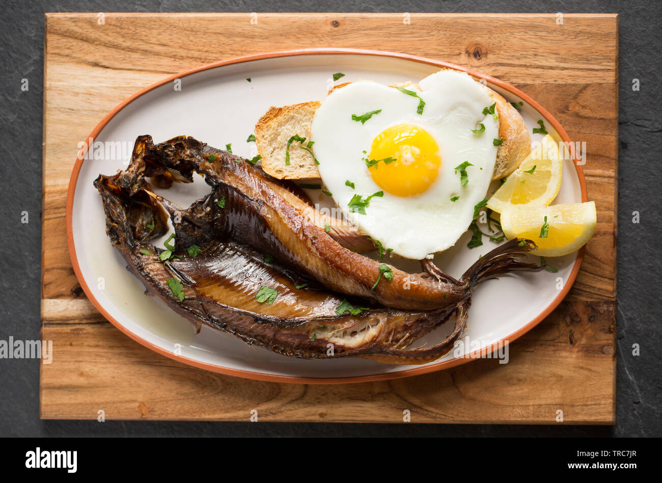 A grilled cold-smoked Craster Kipper made from an Atlantic herring ...