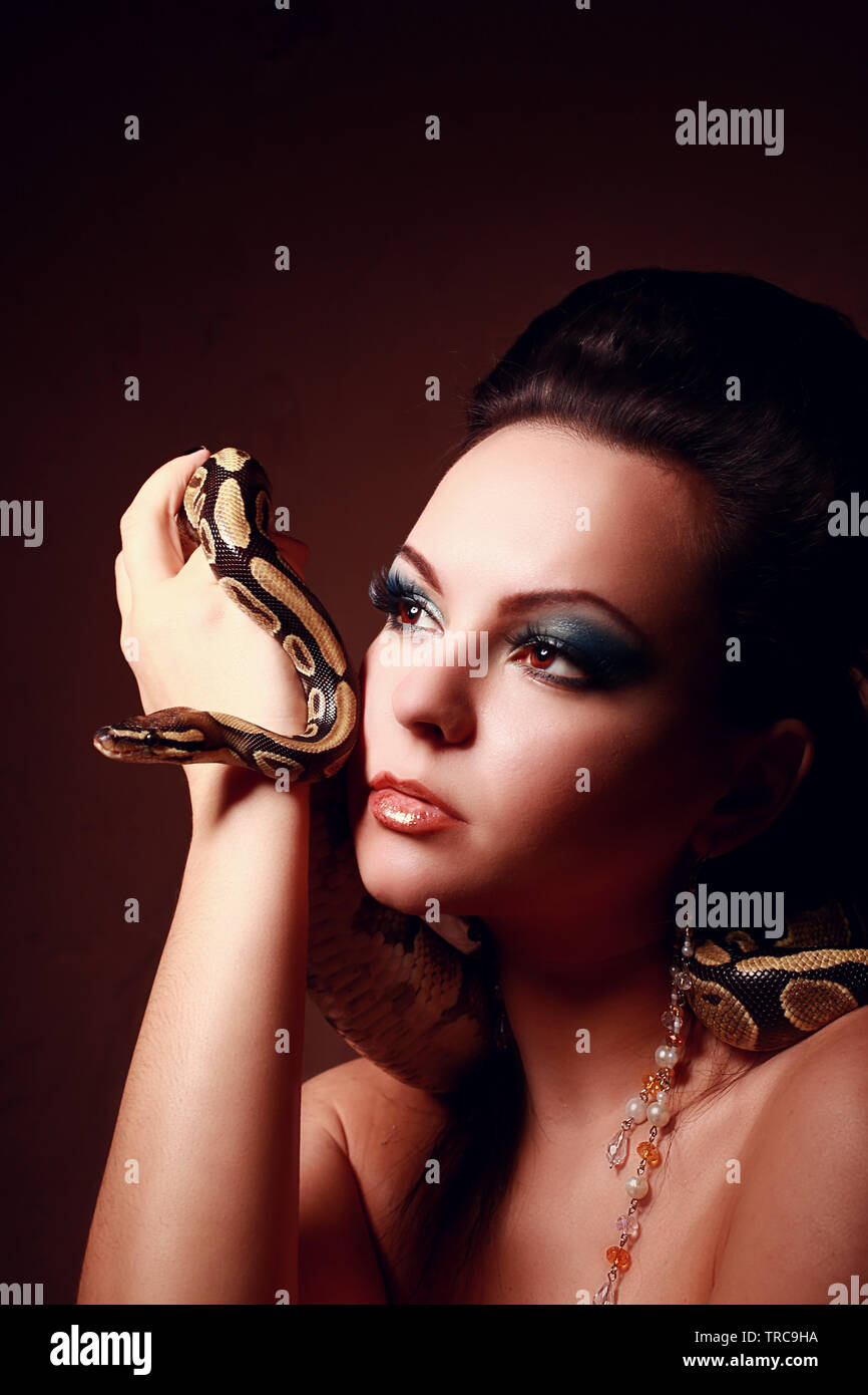Portrait of Beautiful Woman in studio with dangerous snake Stock Photo ...