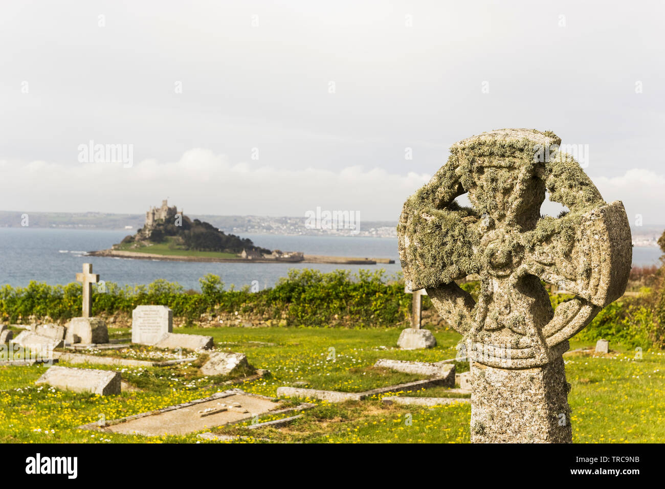 Celtic crosses in a Cornwall cemetery with St Michael's Mount in the ...