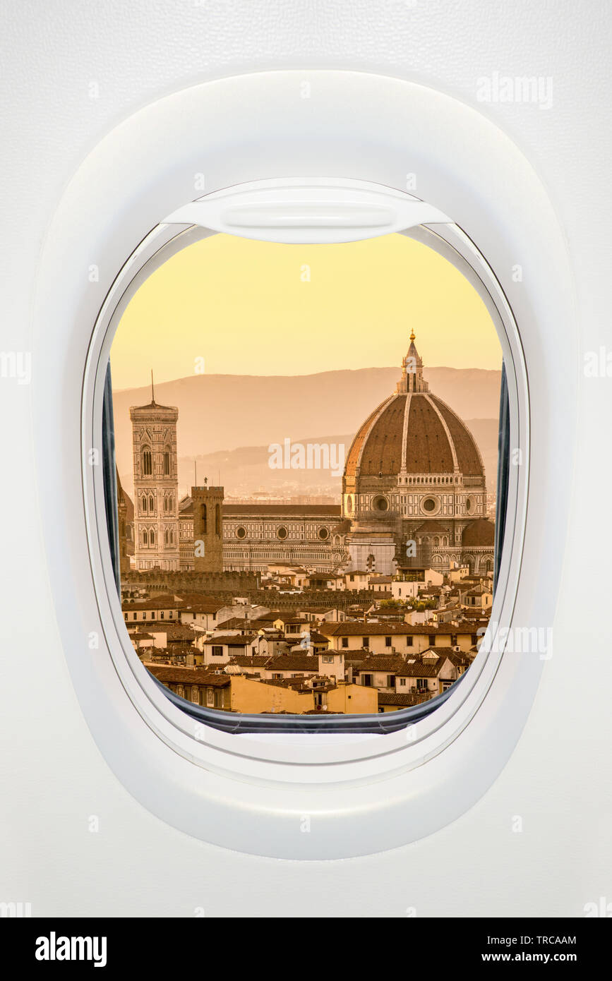 Florence at sunset seen through the window of airplane, travel in ...