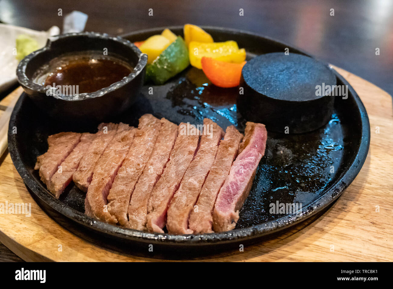 Beef medium rare steak sliced on hot stone pan in japanese restaurant ...
