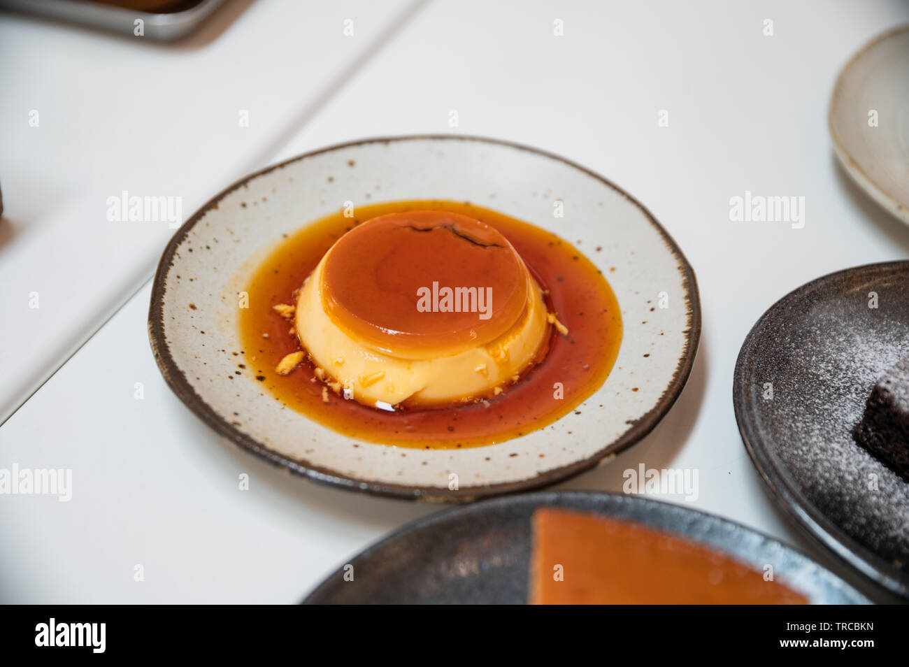 Caramel pudding cake with juicy on ceramic dish Stock Photo - Alamy