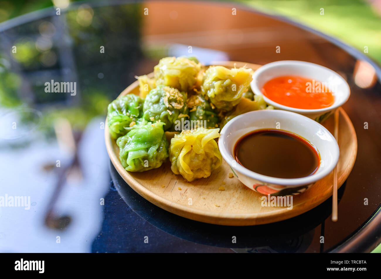 Yellow and green dumpling dim sum stuffed with pork and shrimp with ...