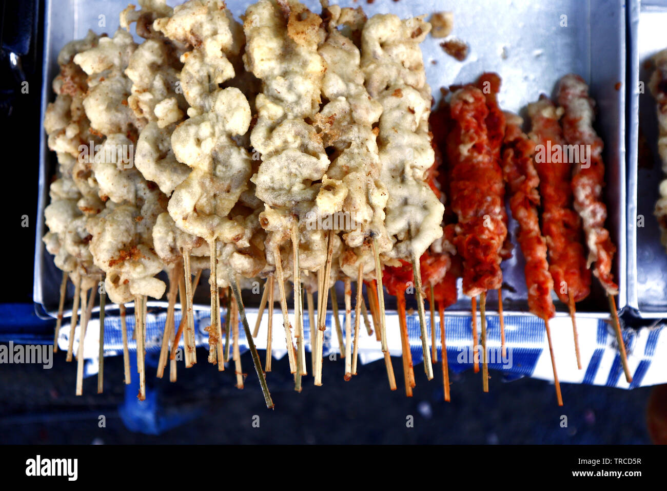 Photo of assorted deep fried chicken innards on display at a food cart ...
