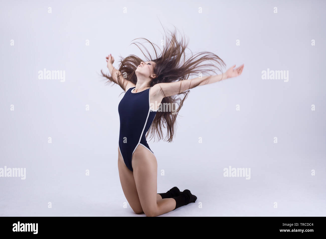 young beautiful dancer posing on a studio background Stock Photo - Alamy
