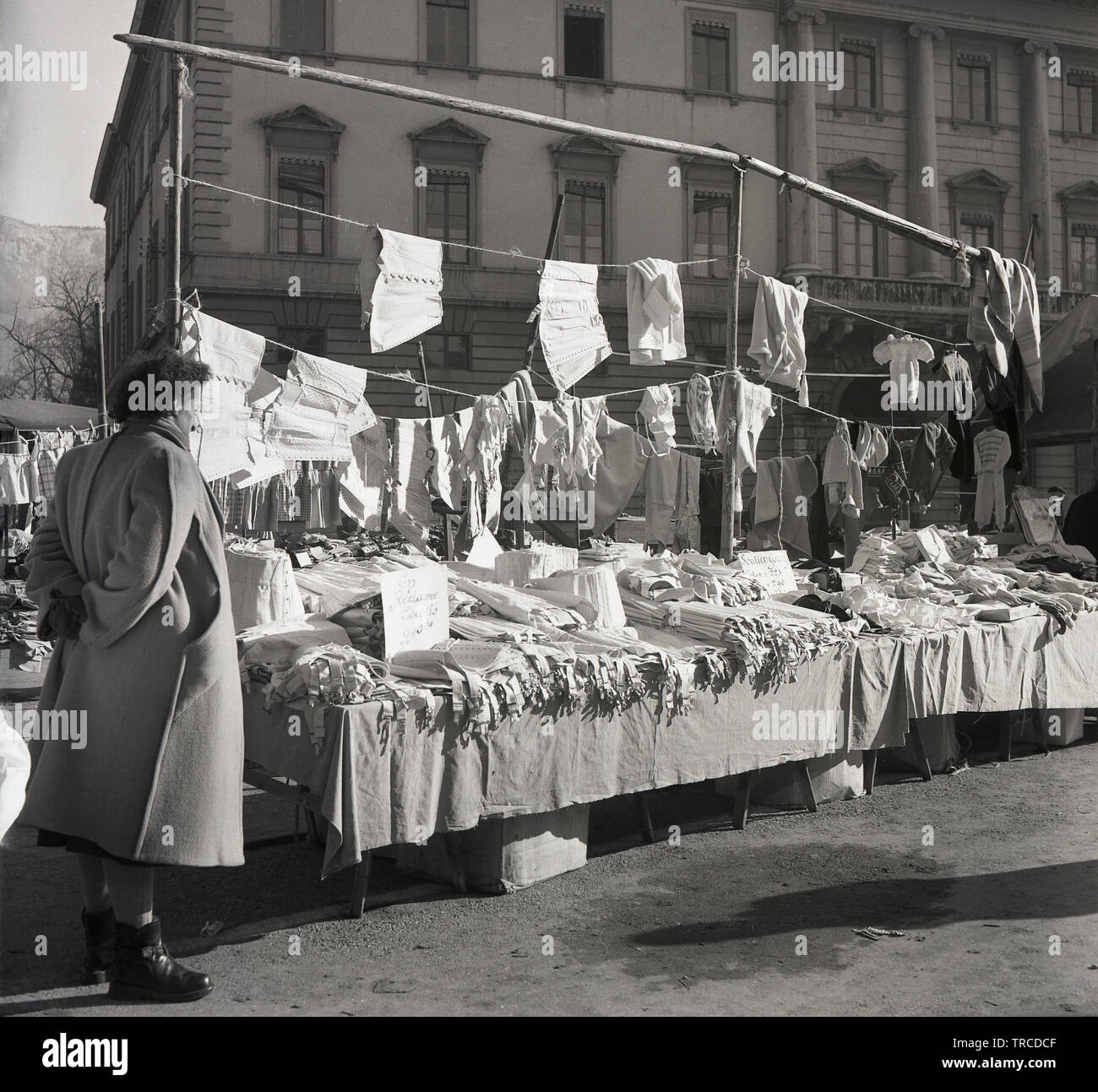 1950s, historical, a female stall-holder standing by her market stall ...