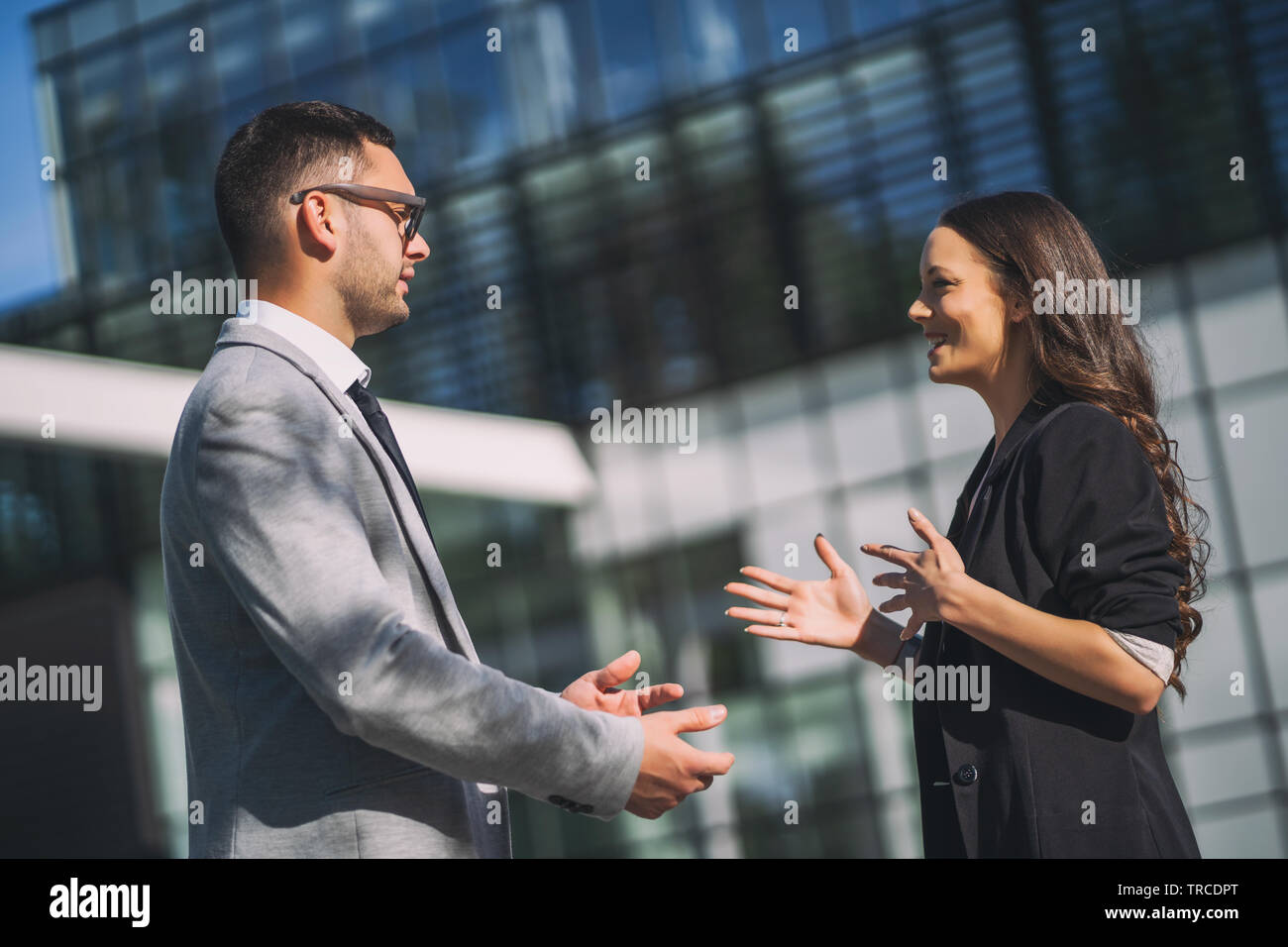 Business colleagues are talking outside the company building Stock ...