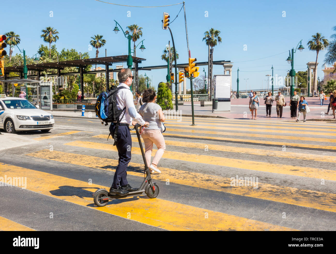 Man on Electric scooter crossing on a pedestrian walkway. Malaga ...