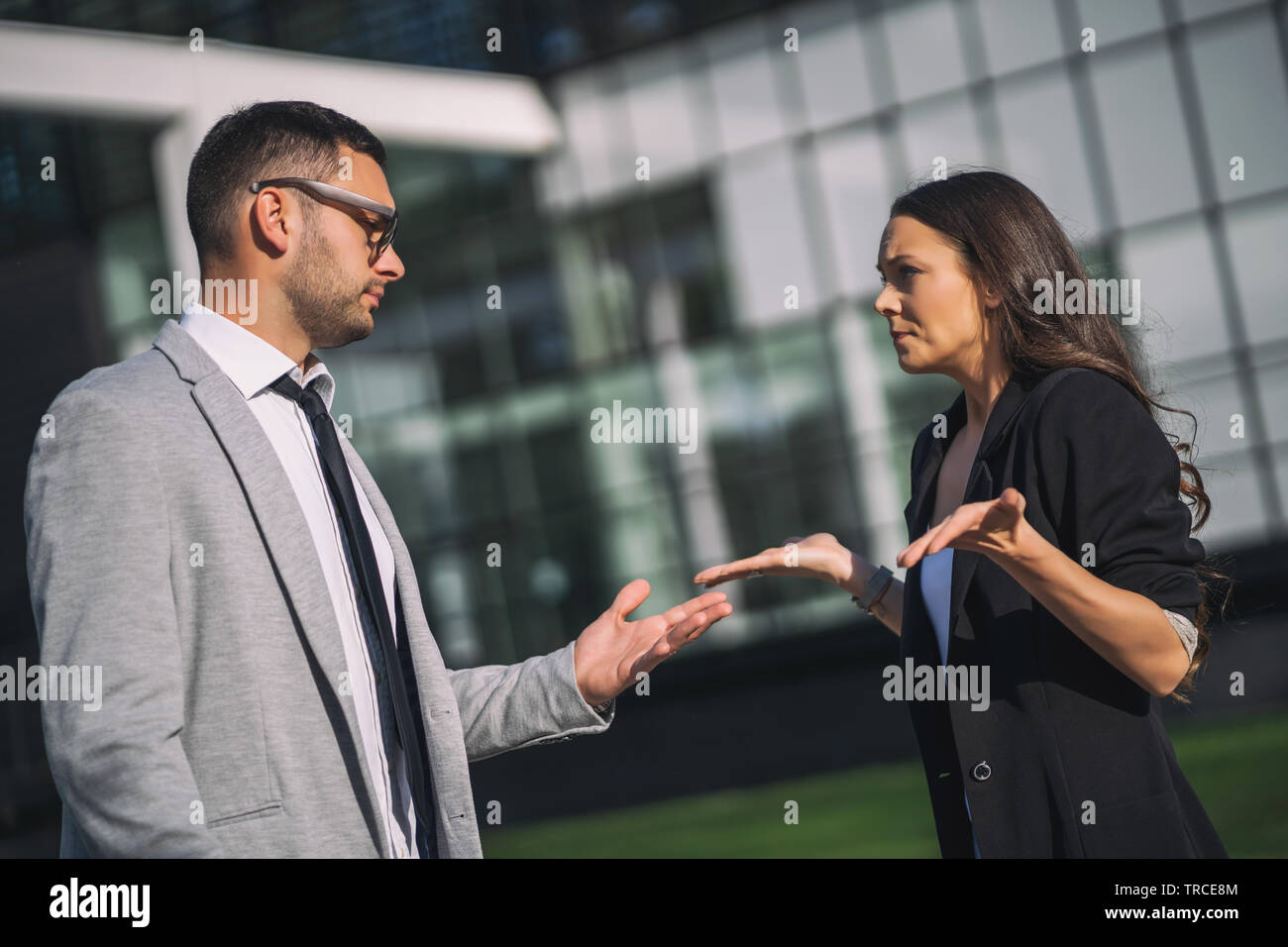 Business colleagues are arguing outside the company building Stock ...