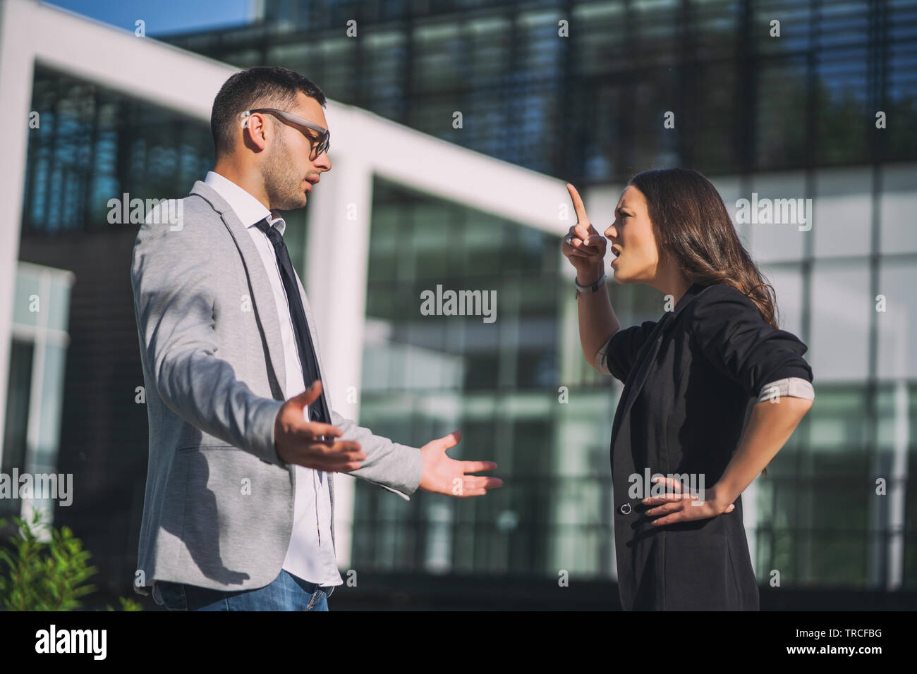 Business colleagues are arguing outside the company building Stock ...
