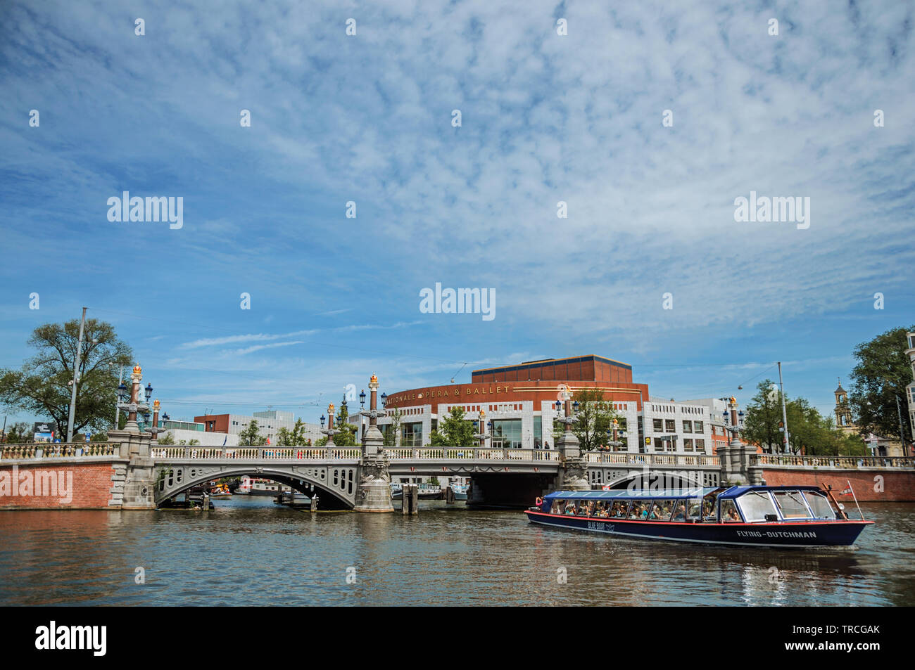 Boat and bridge on canal in front the Dutch National Opera & Ballet at ...