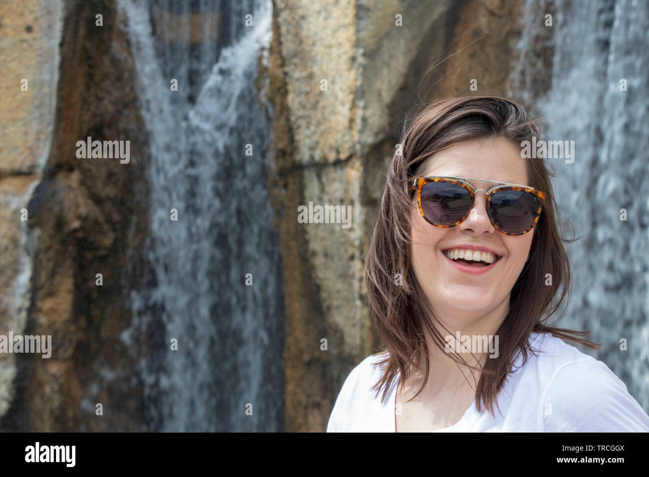woman laughing by a waterfall Stock Photo - Alamy
