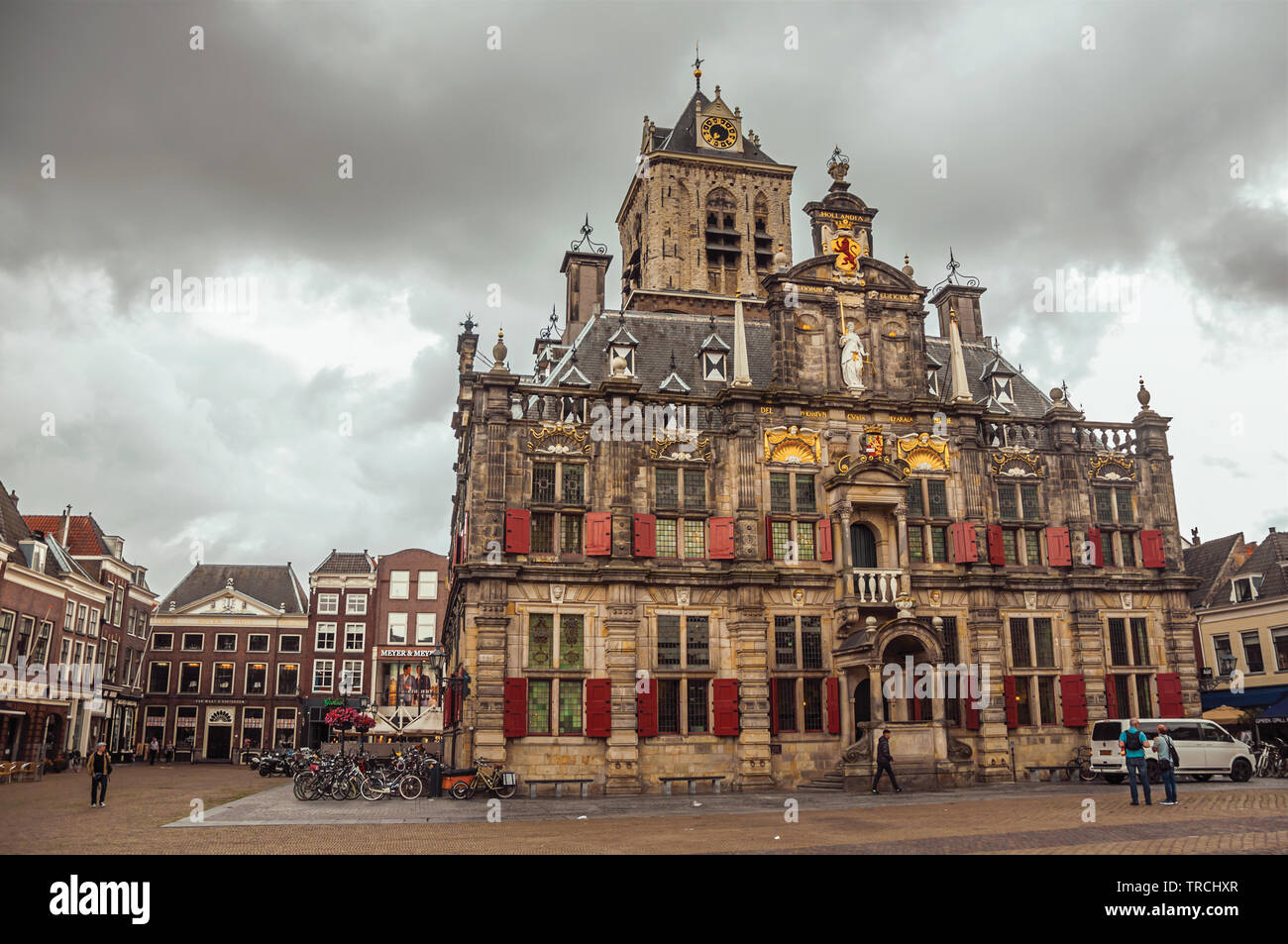 People on Market Square and decorated Gothic City Hall building in ...