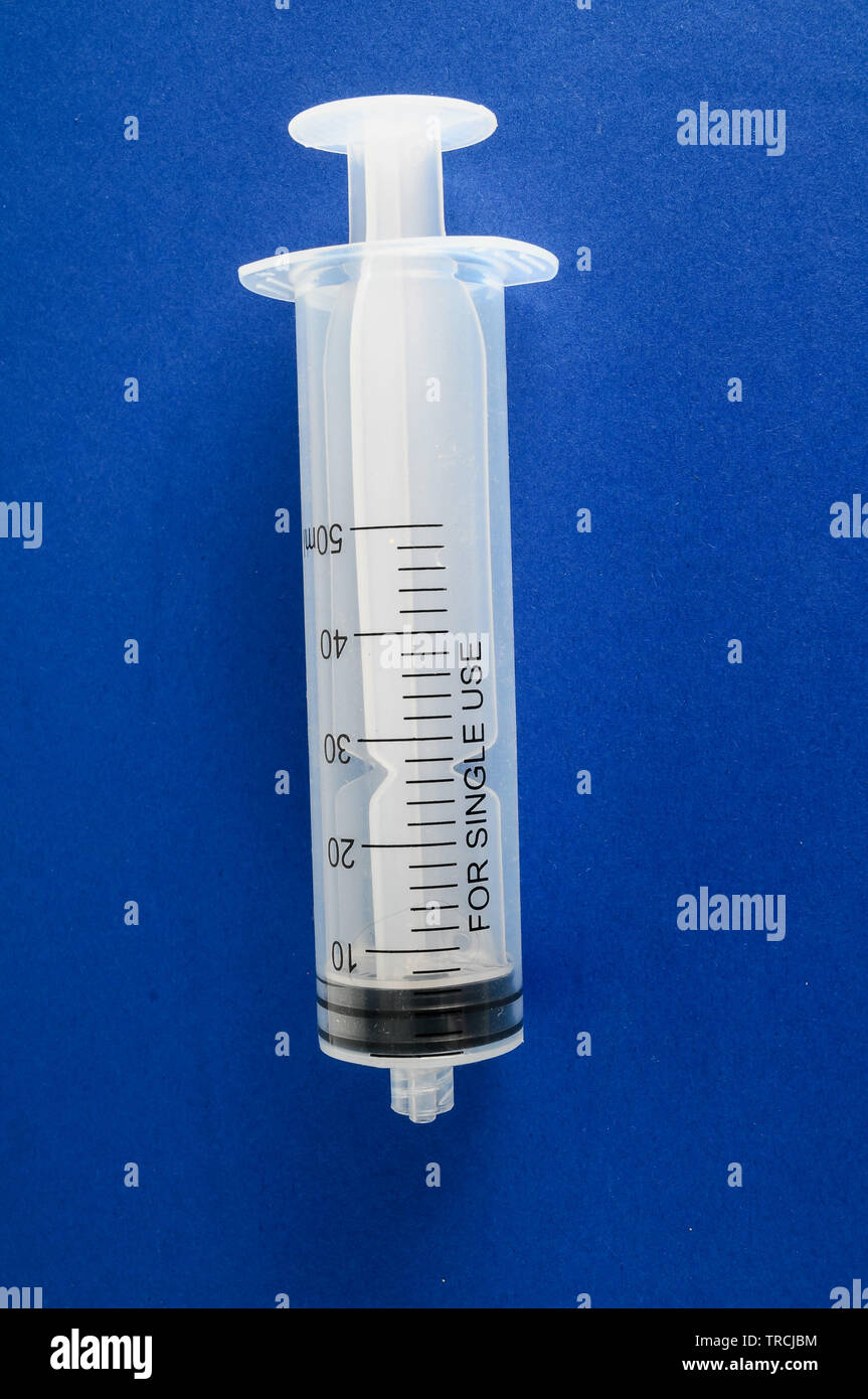 Photo of Syringe closeup isolated on colred background Stock Photo - Alamy