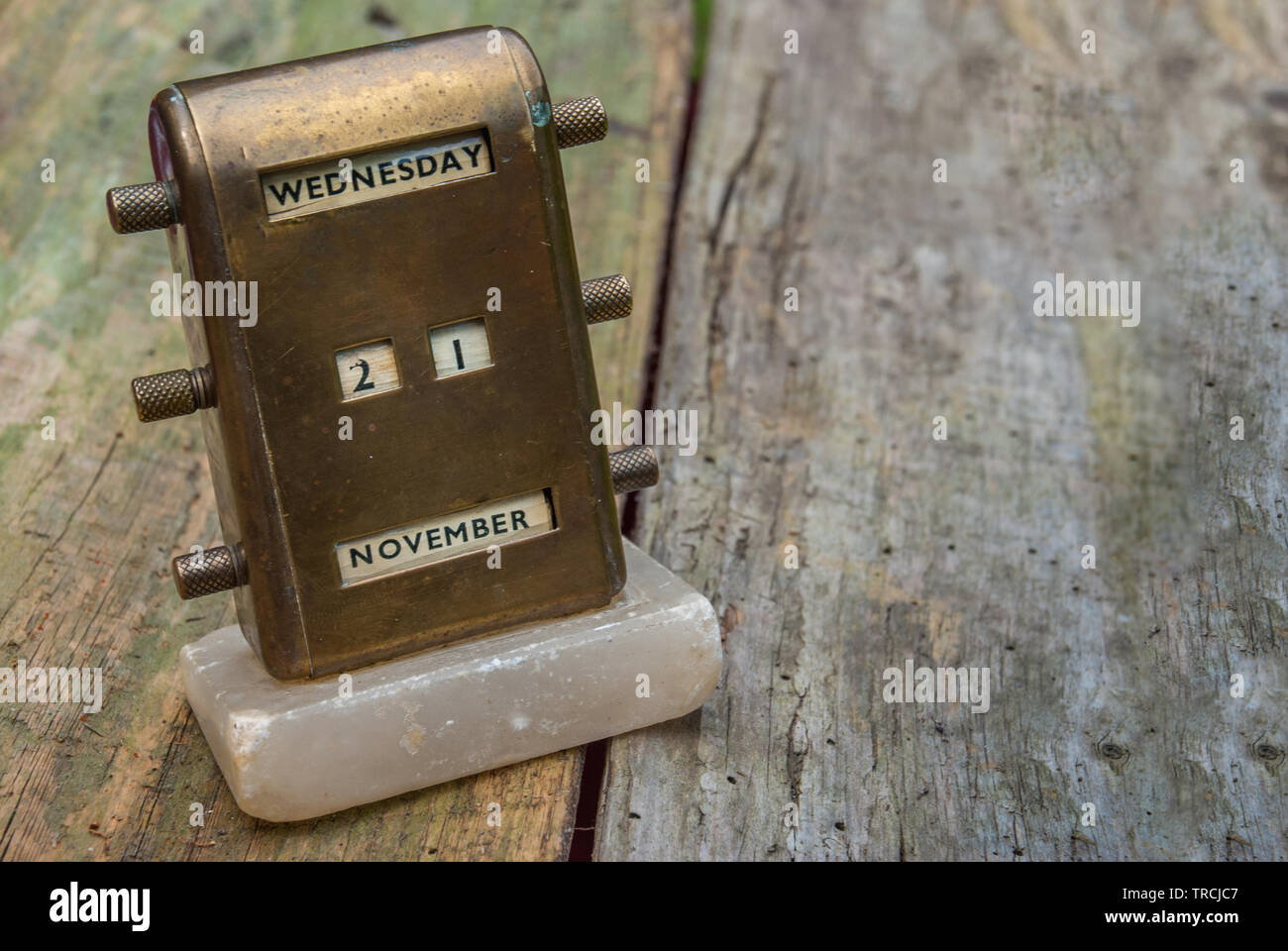 Antique Brass Desktop Perpetual Calendar on an Old wooden floor Stock ...