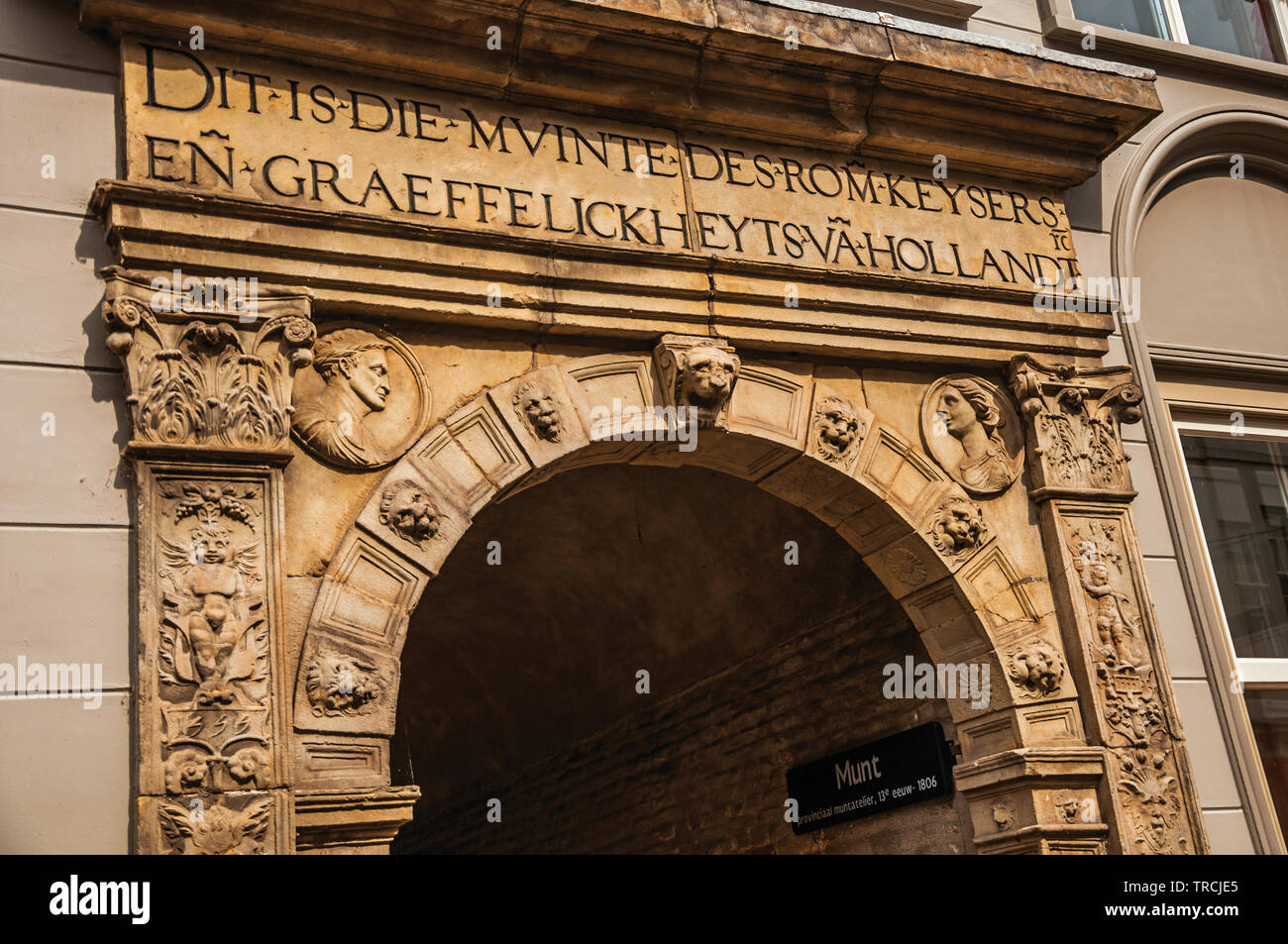 Stone arch decorated with inscriptions and embossed sculptures in ...