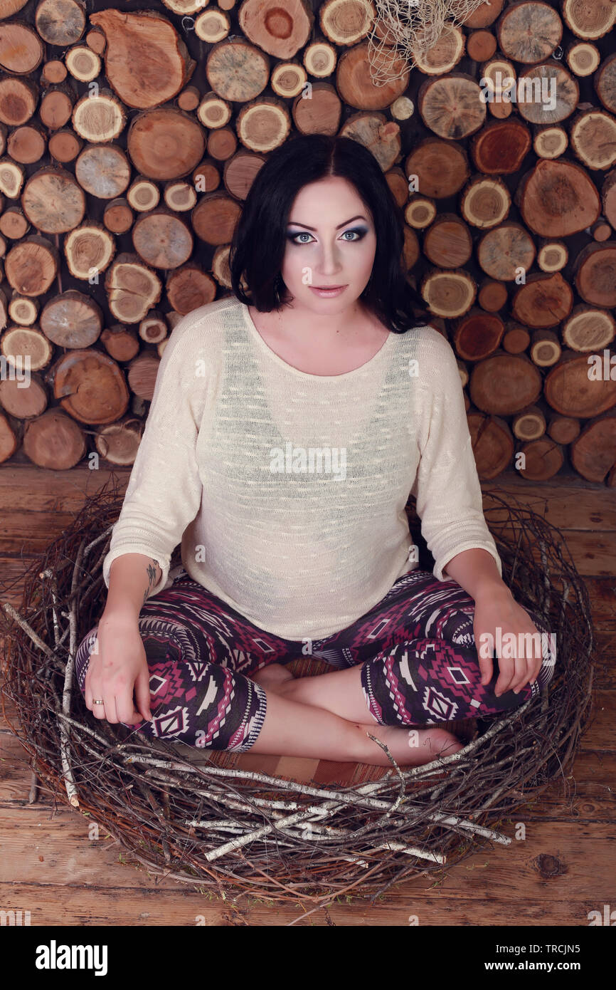 Expectant mother in the studio. Pregnant girl on a wooden background ...