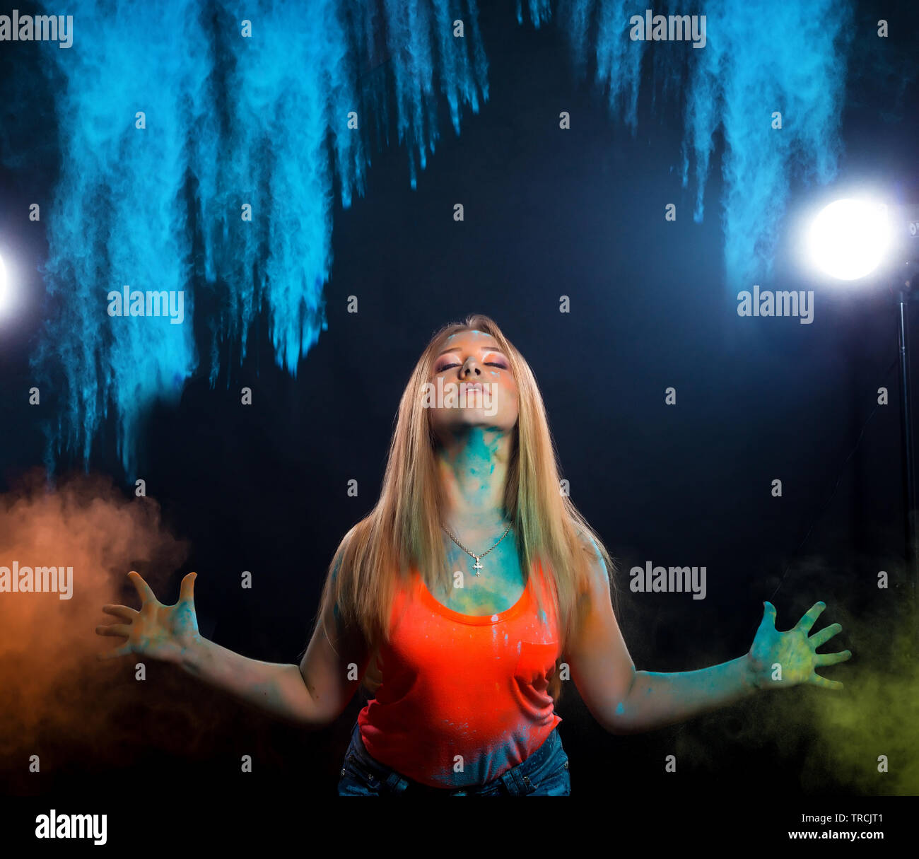 girl with colored powder exploding around her and into the background ...