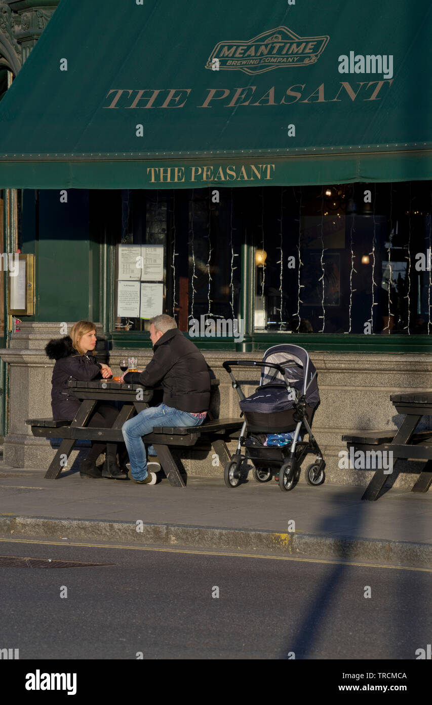 Couple sitting outside in a pub in Clerkenwell, Islington,London ...