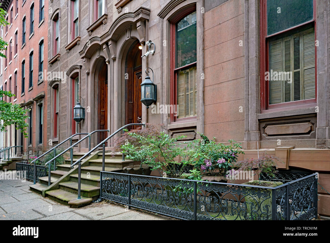 urban street with old brownstone style townhouses or apartment ...