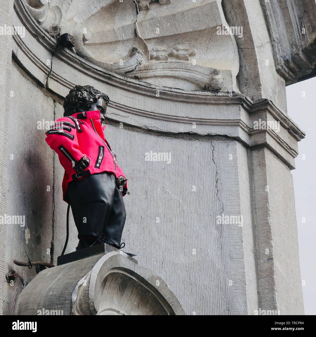 Brussels, Belgium - May 2019: Mannekin Pis in a pink zipper jacket ...