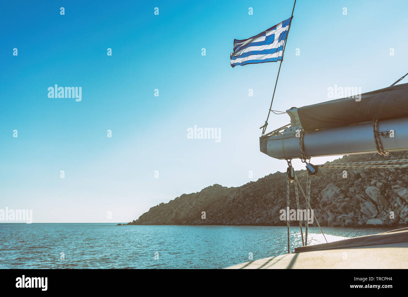 Greek flag flying on a sailboat during a tour around Mykonos Stock ...