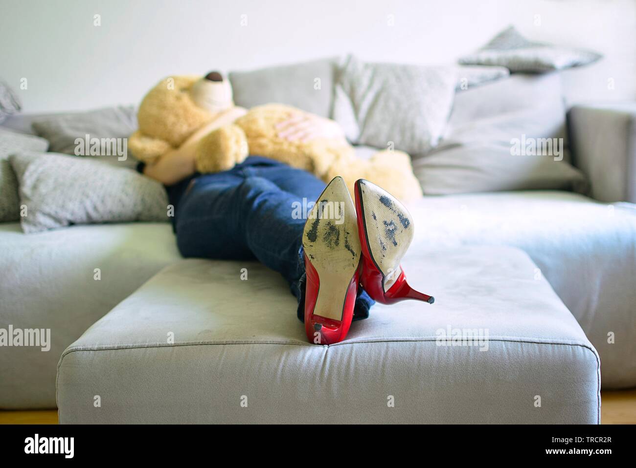 Woman lying sofa arms hi-res stock photography and images - Alamy
