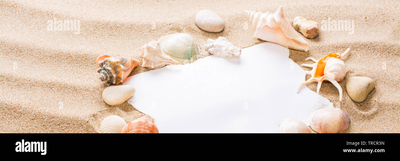 Message in torn paper on the beach. Summer background with hot sand ...