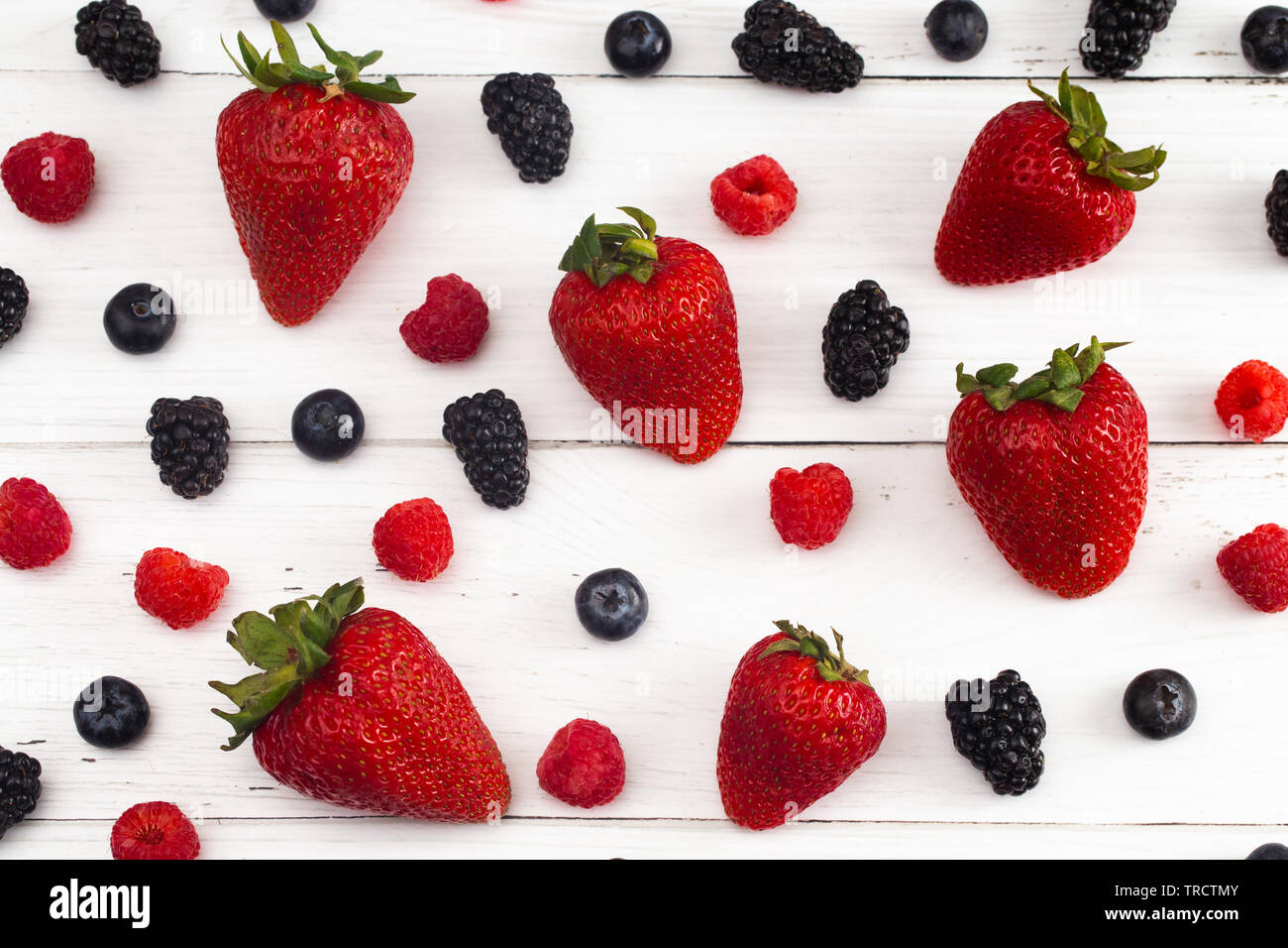 Fruits of the Forest Berries on a White Wood Table Stock Photo - Alamy