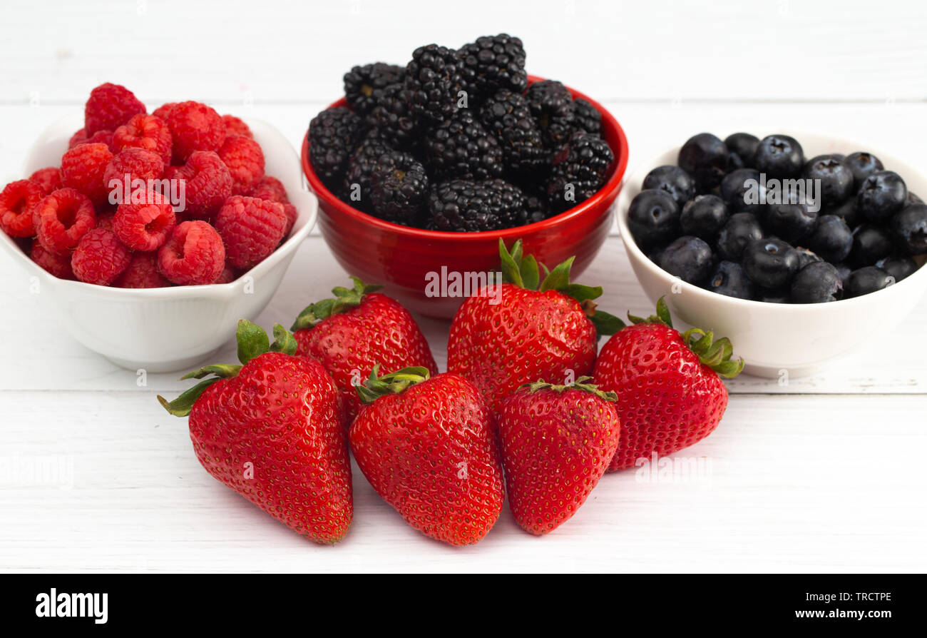 Fruits of the Forest Berries on a White Wood Table Stock Photo - Alamy