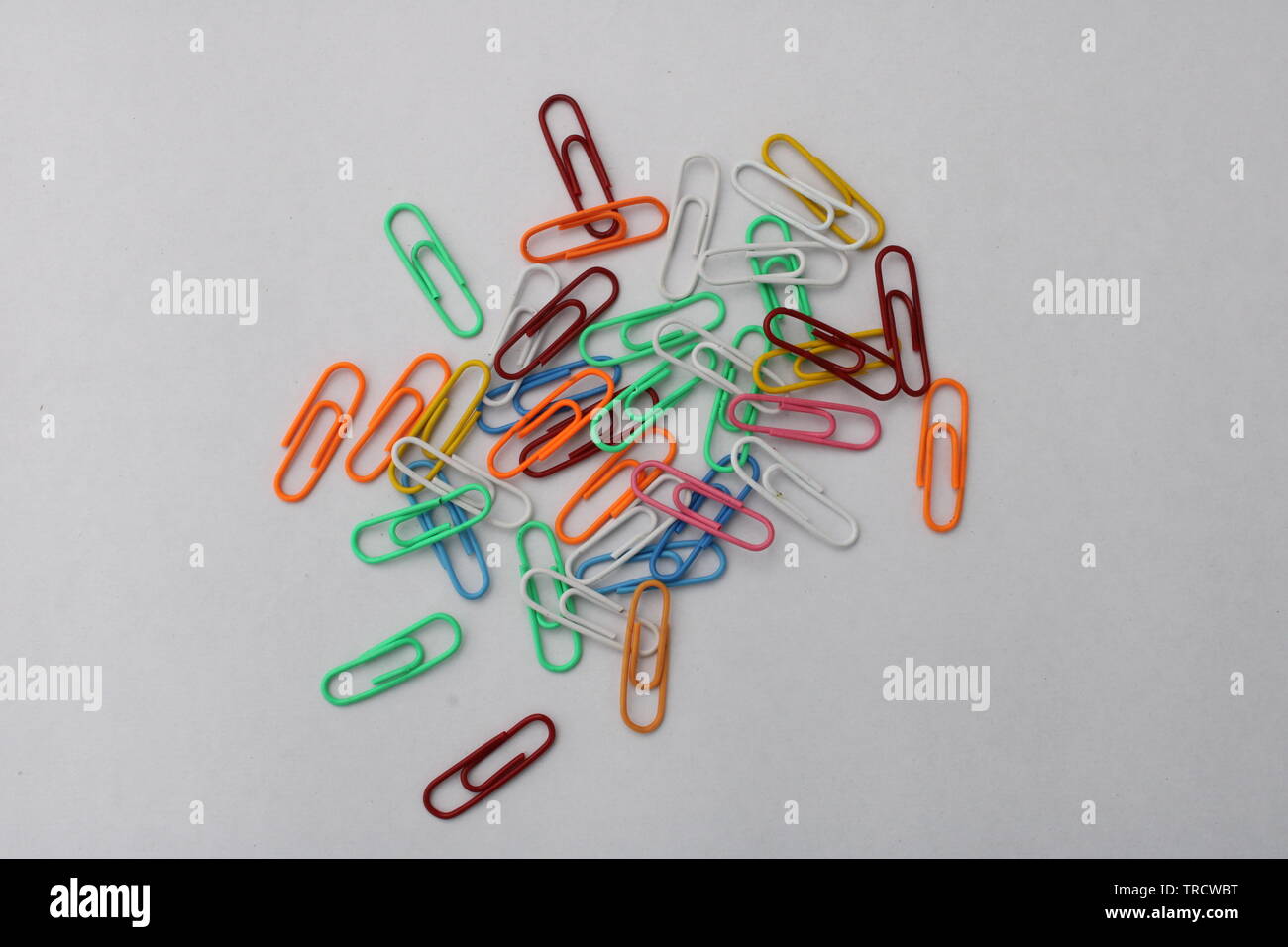 colorful paper clips on white background Stock Photo - Alamy