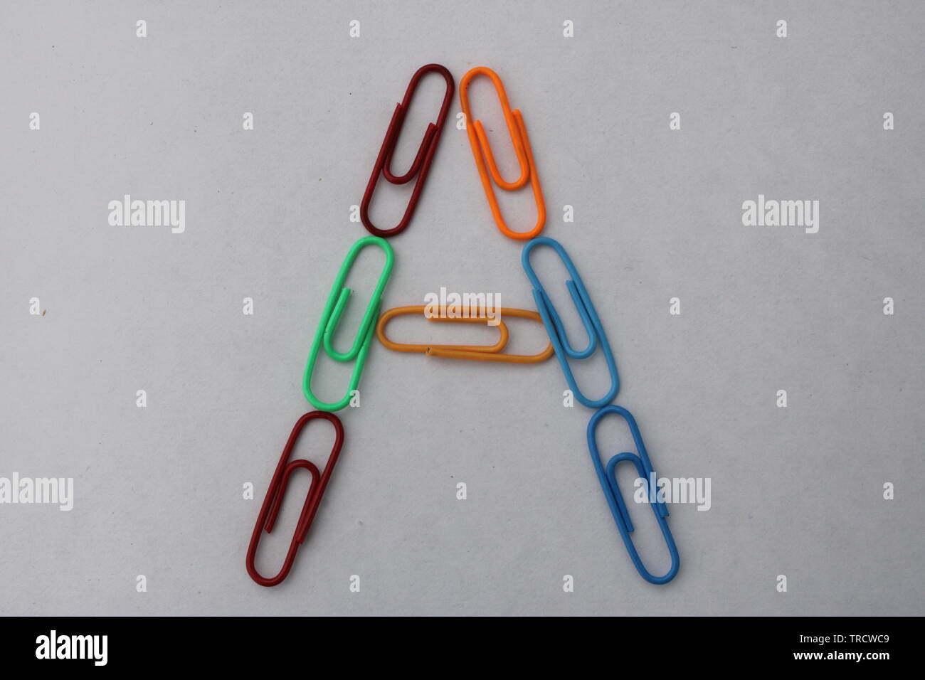 Letter A made with colorful paper clips on white background Stock Photo ...