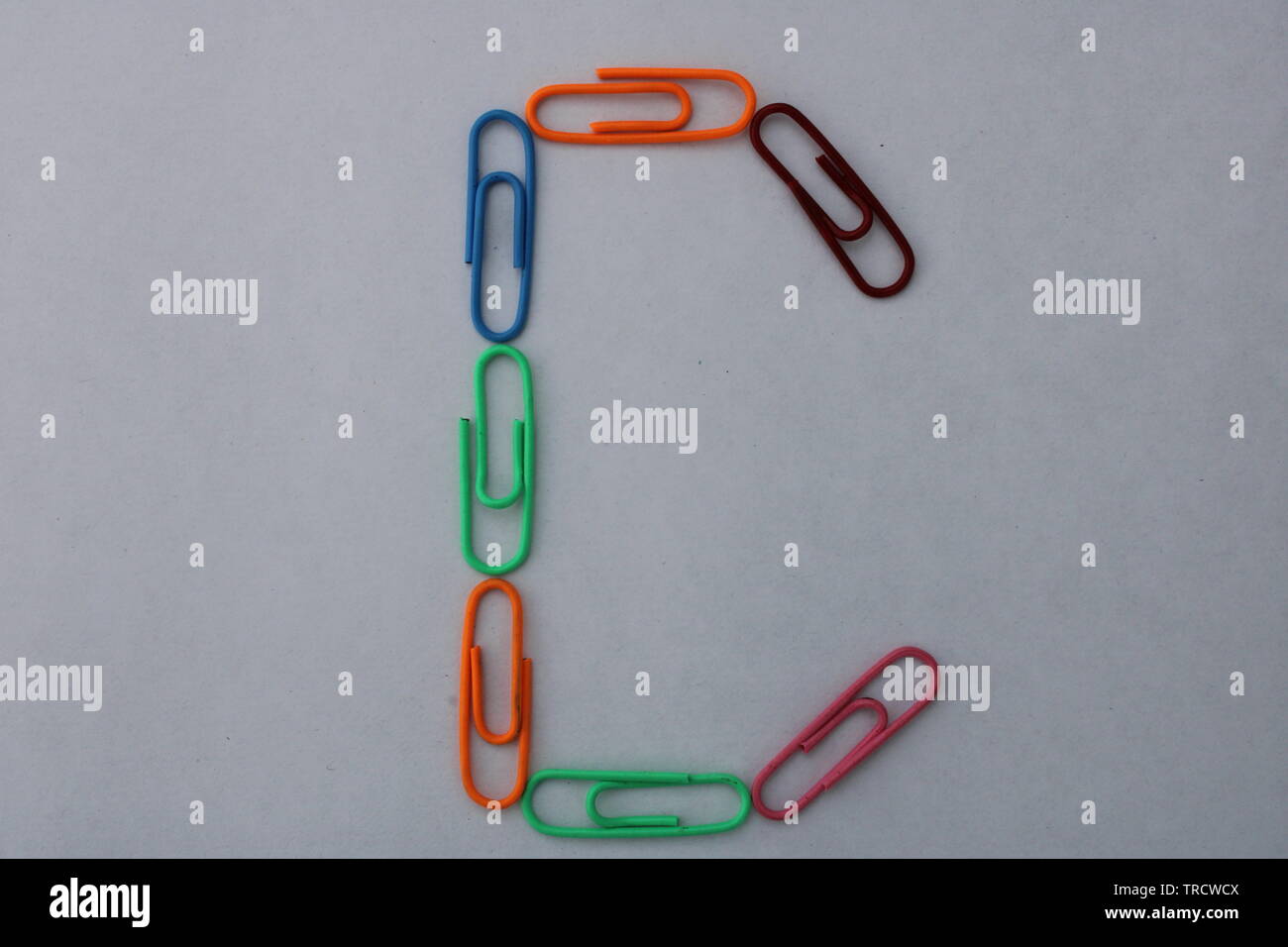 Letter C made with colorful paper clips on white background Stock Photo ...