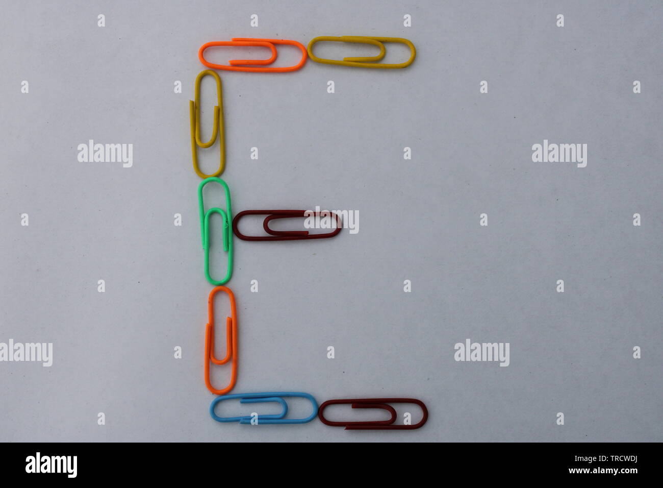 Letter E made with colorful paper clips on white background Stock Photo ...