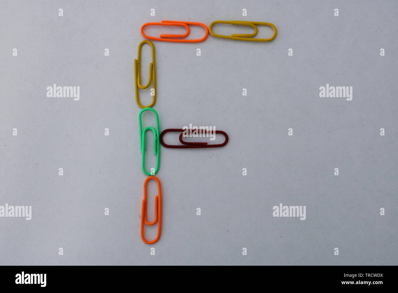 Letter F made with colorful paper clips on white background Stock Photo ...